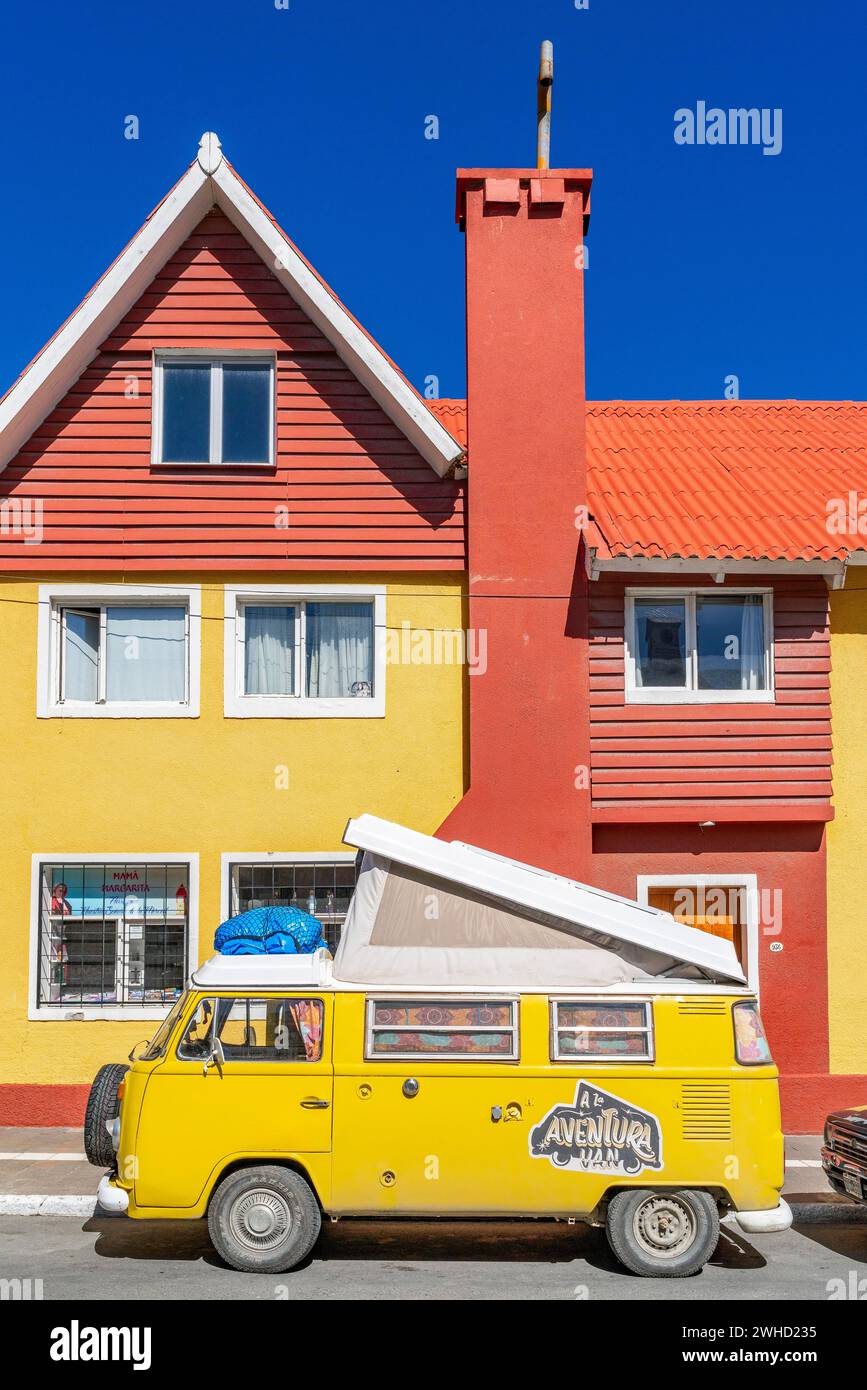 Yellow Volkswagen van in retro style in front of a yellow and red house ...