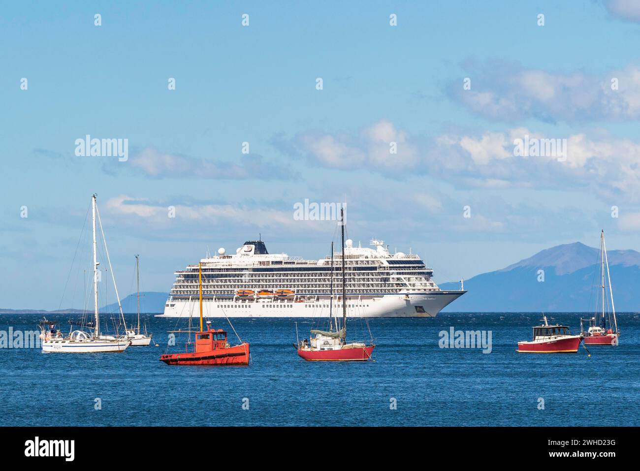Yachts and fishing boats anchored in front of a cruise ship in the ...
