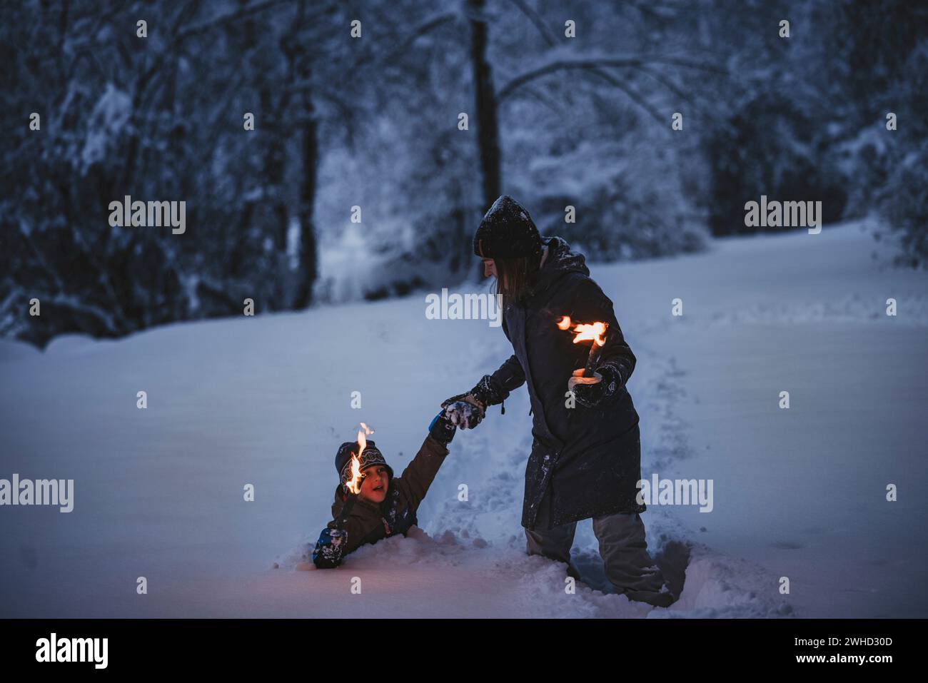 Family torchlight hike in the forest Stock Photo - Alamy