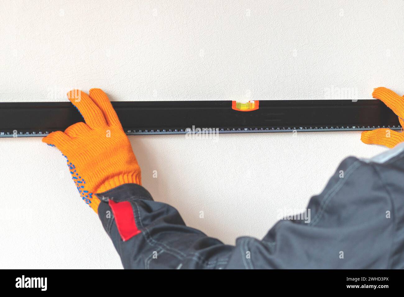 Worker's hands with bubble level. measuring with bubble level ...