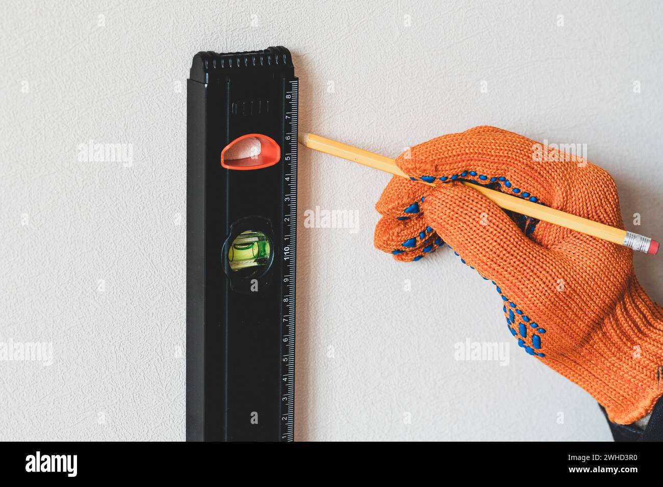 Worker's hands with bubble level. measuring with bubble level ...