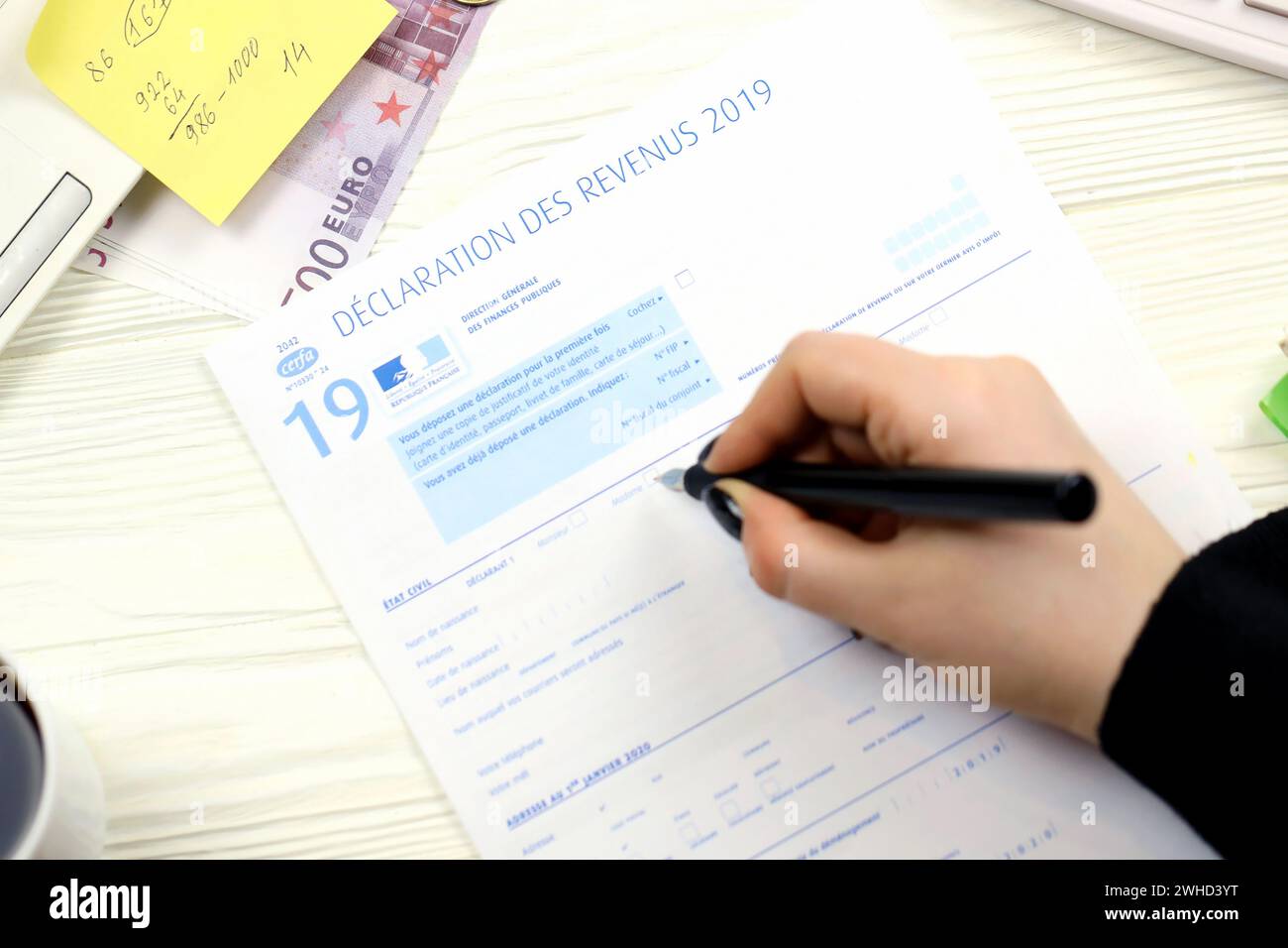 KYIV, UKRAINE - OCTOBER 31, 2023 Accountant fill french tax form 2042 ...