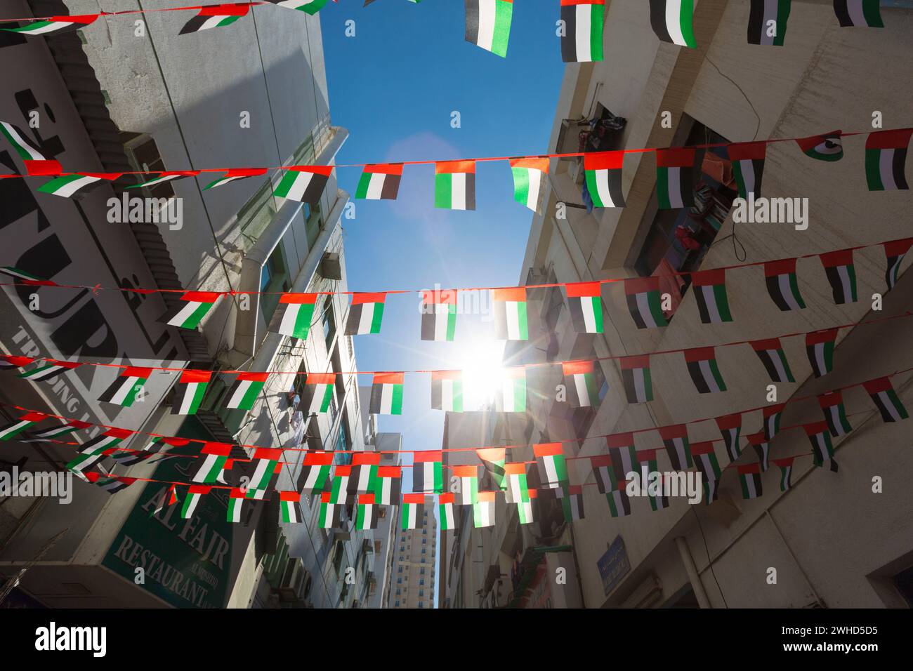 Small buntings of UAE flags displayed over old buildings in bur Dubai ...