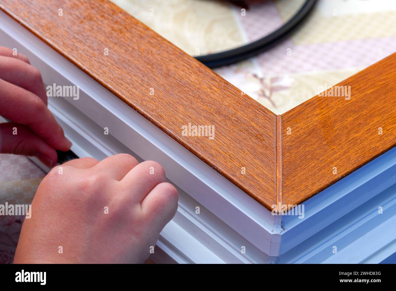 Hands applying rubber strip. Concept improvement of sealing, sound ...