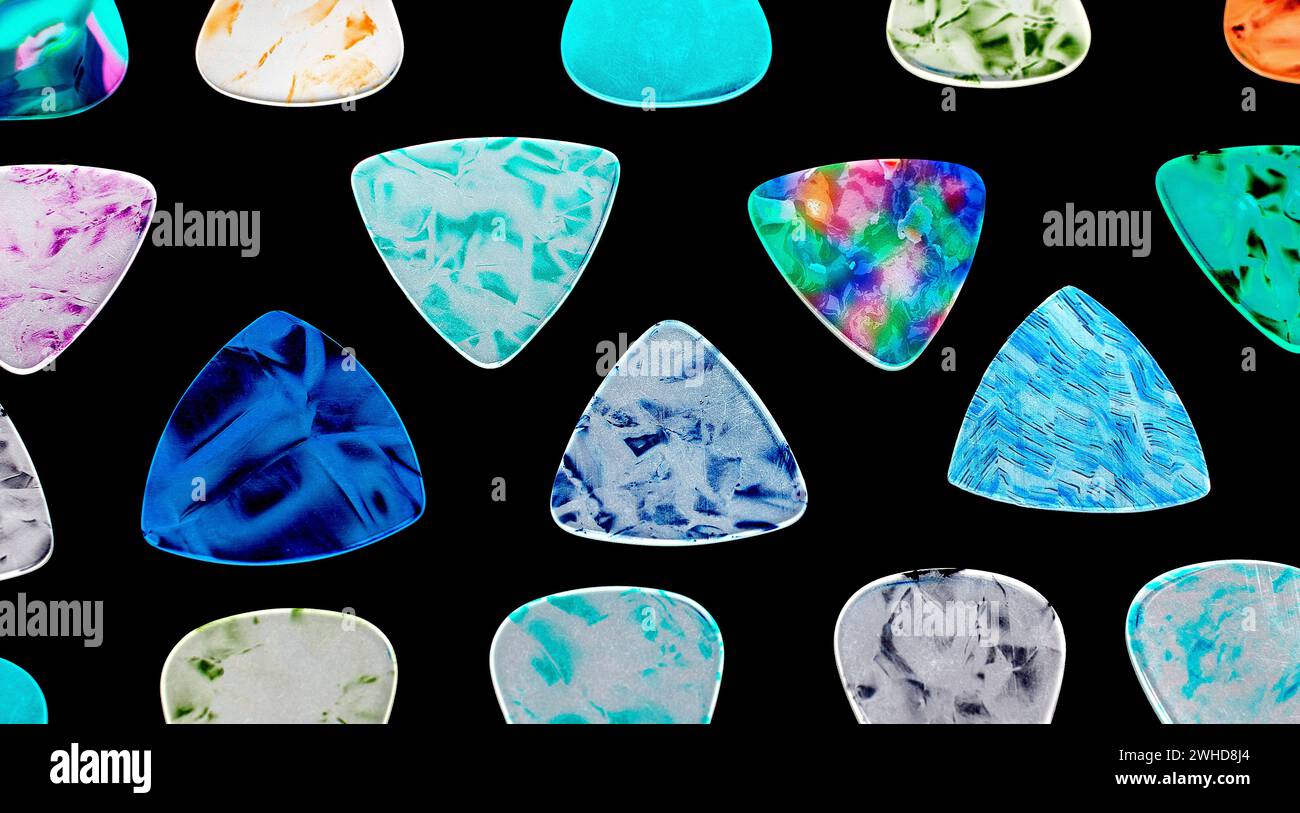 Multicoloured Pile Stacked of Guitar Plectrums and Picks Against Black ...