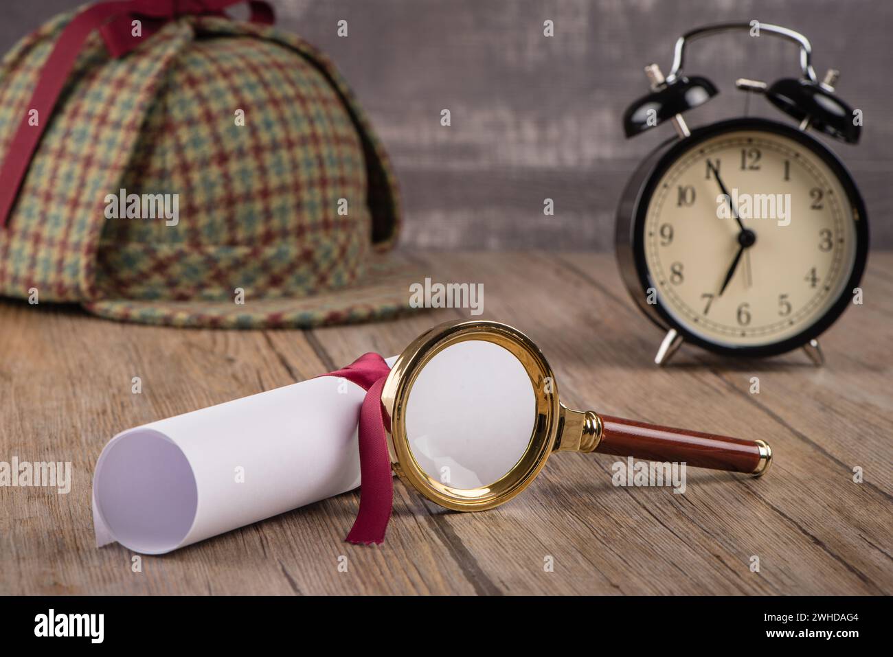 Wrapped paper sheets and magnifying glass Stock Photo - Alamy