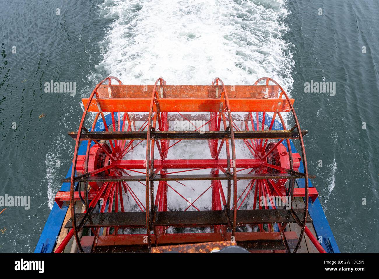 A top-down view of a red paddle wheel on the back of a paddle boat ...
