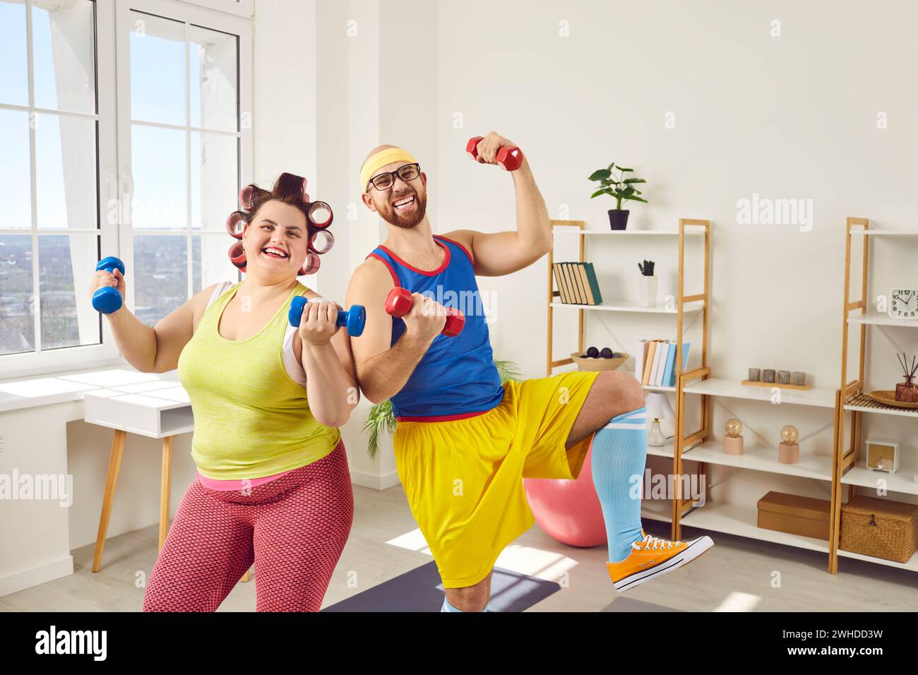Funny overweight fat woman with bearded man in bright sportswear doing ...