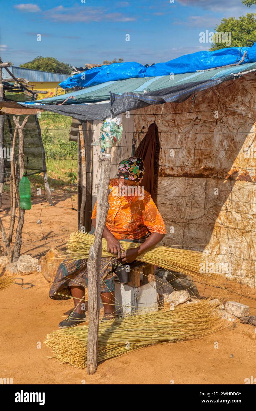 african old entrepreneur woman making bundles of thatch , street vendor ...