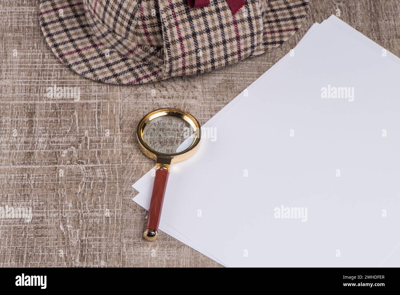 Paper sheets and magnifying glass Stock Photo - Alamy