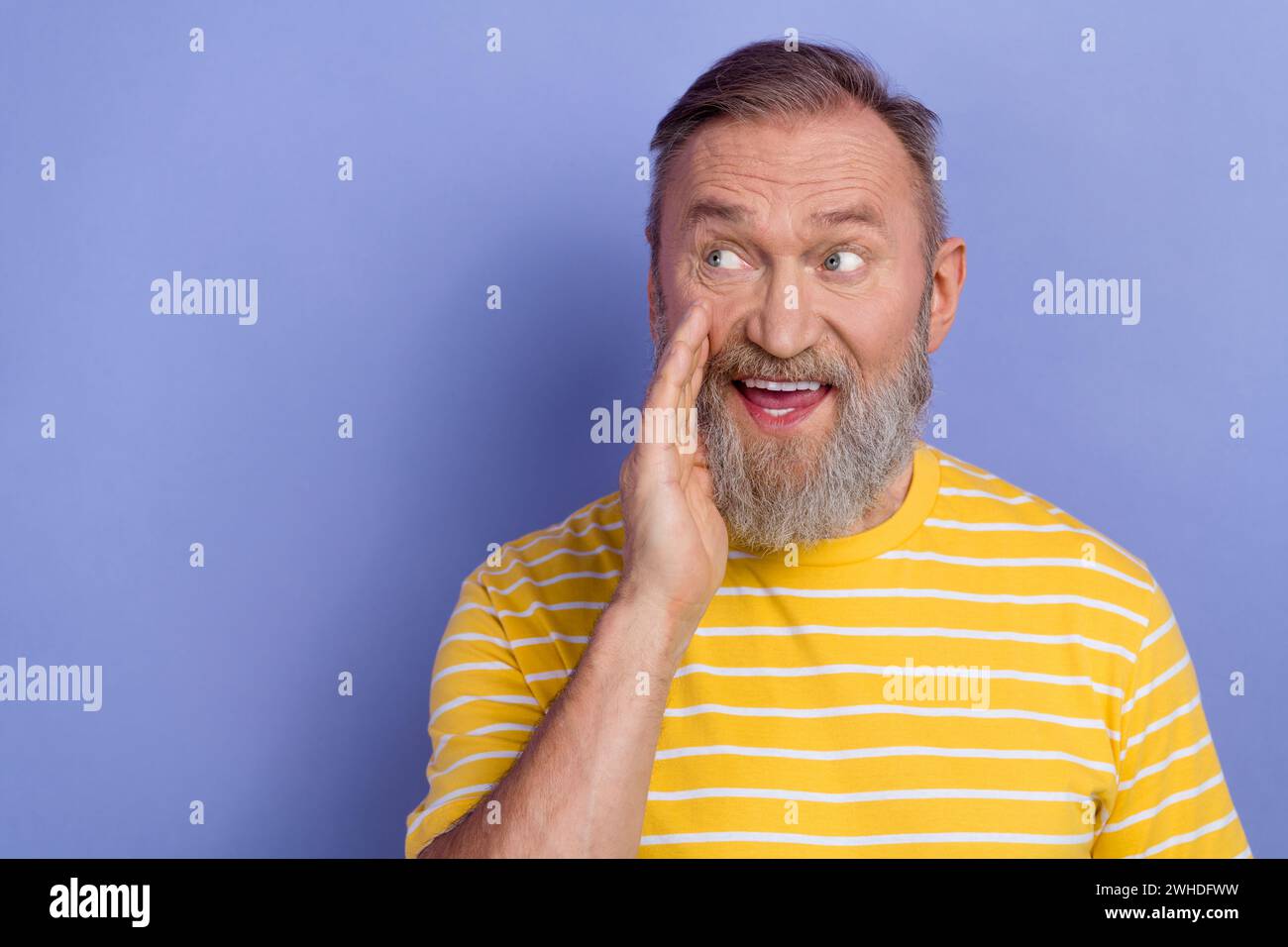 Photo of impressed senior man dressed striped t-shirt palm on cheek ...