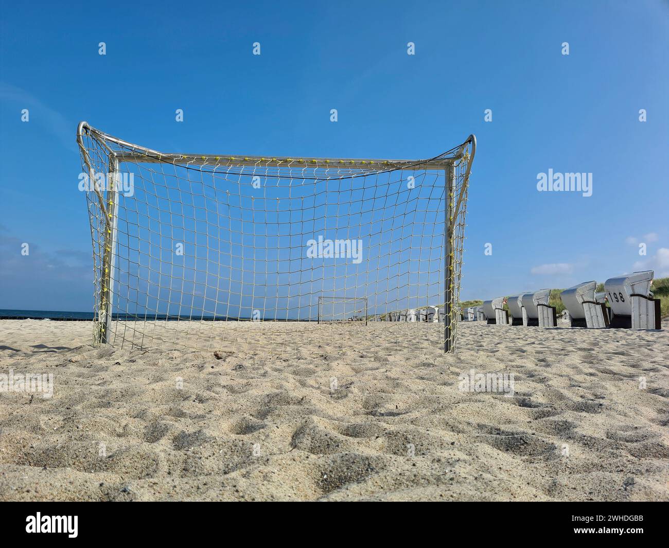View of the sea on the horizon through the soccer goal on the beach in ...