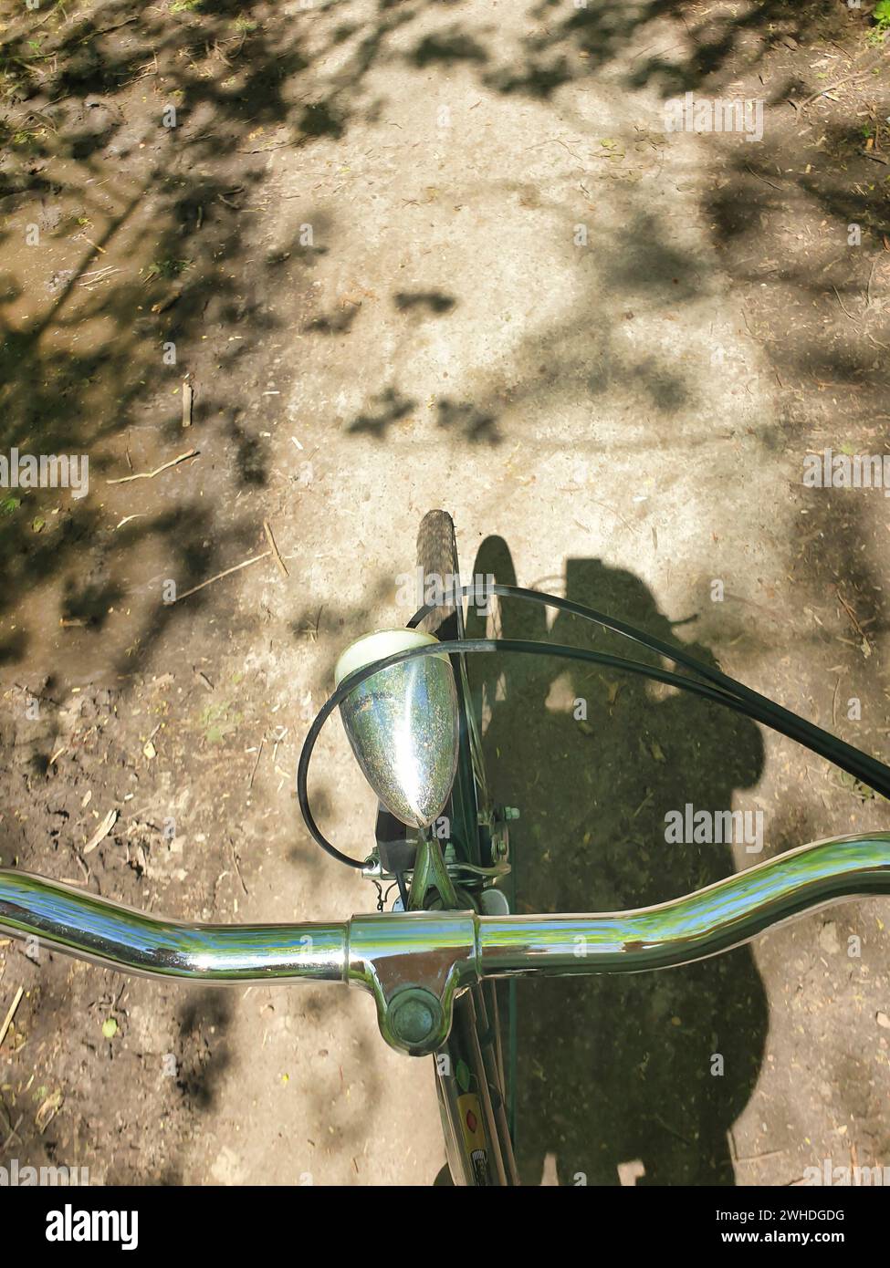 Cycling in nature on a summer's day with light and shade, off into the ...