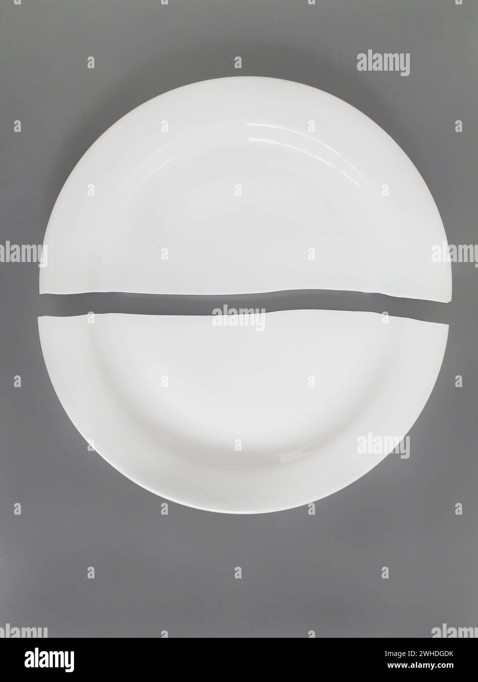 A white plate in 2 halves as a symbol for diet or separation Stock ...