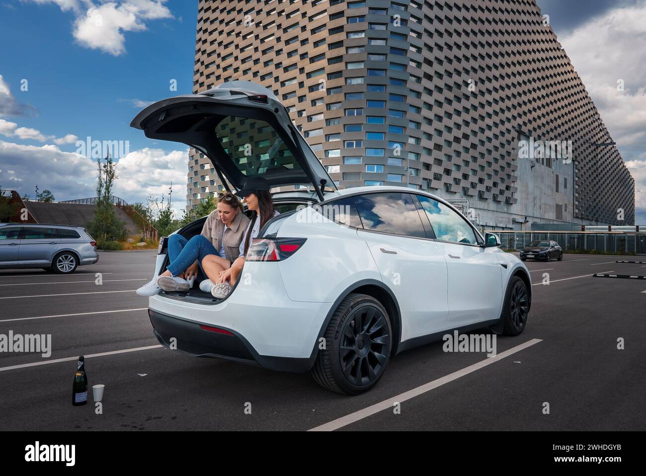 Casual Break in Tesla Model X with Modern Building, Copenhagen Stock ...