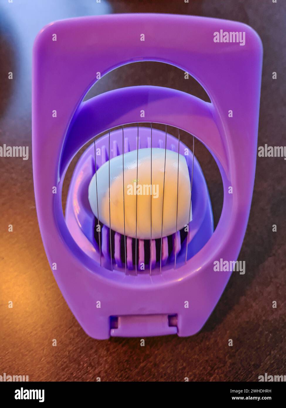 Boiled egg is cut into slices in the egg slicer hi-res stock photography and images - Alamy