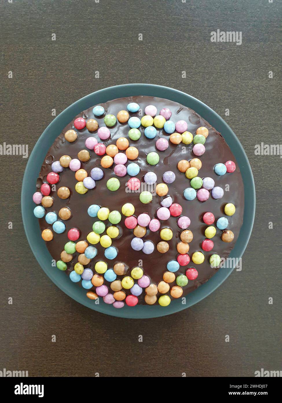 Chocolate cake with Smarties on a plate for a birthday Stock Photo - Alamy