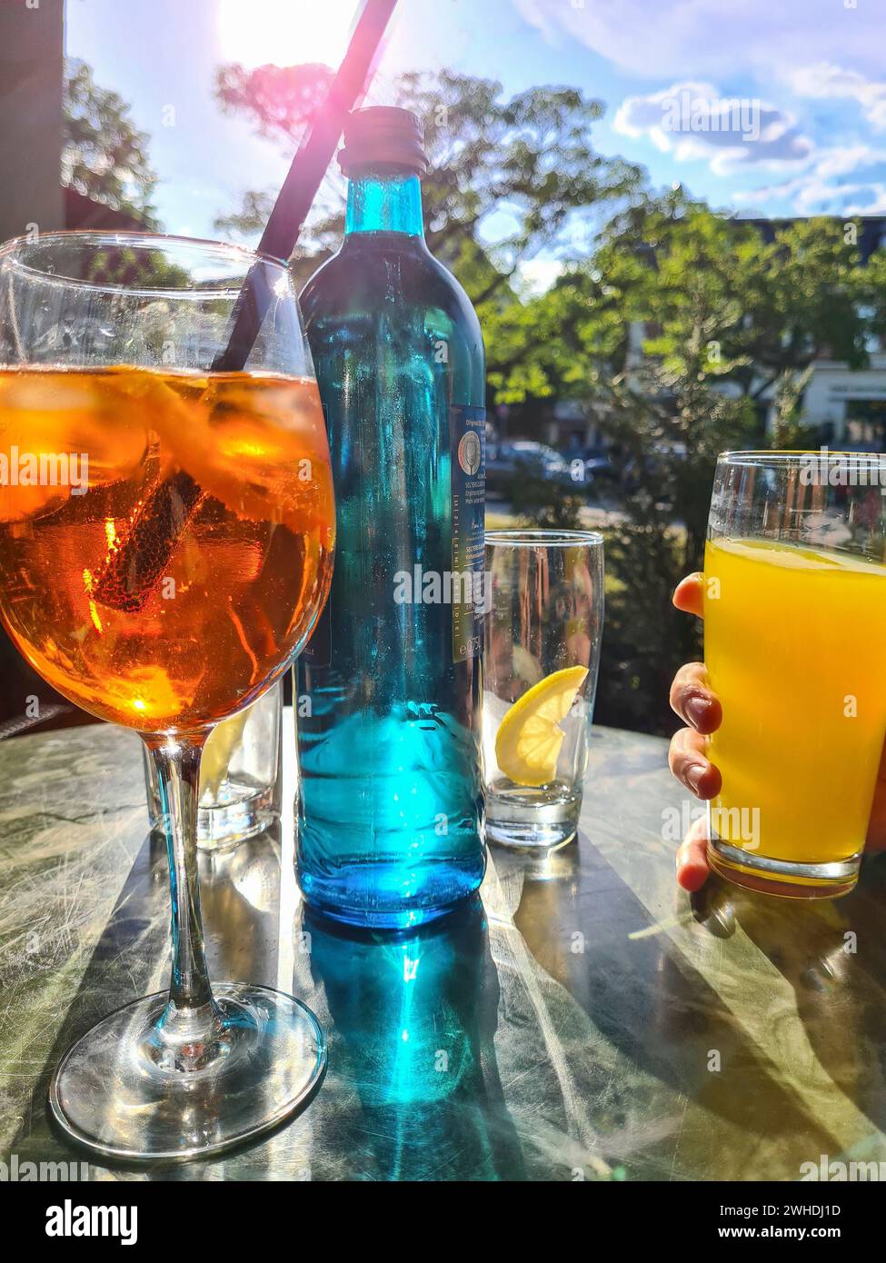 The alcoholic soft drink Aperol Spritz is placed on a table next to a ...