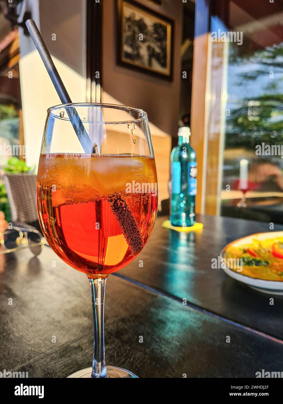 The alcoholic soft drink Aperol Spritz is placed on a table next to a ...
