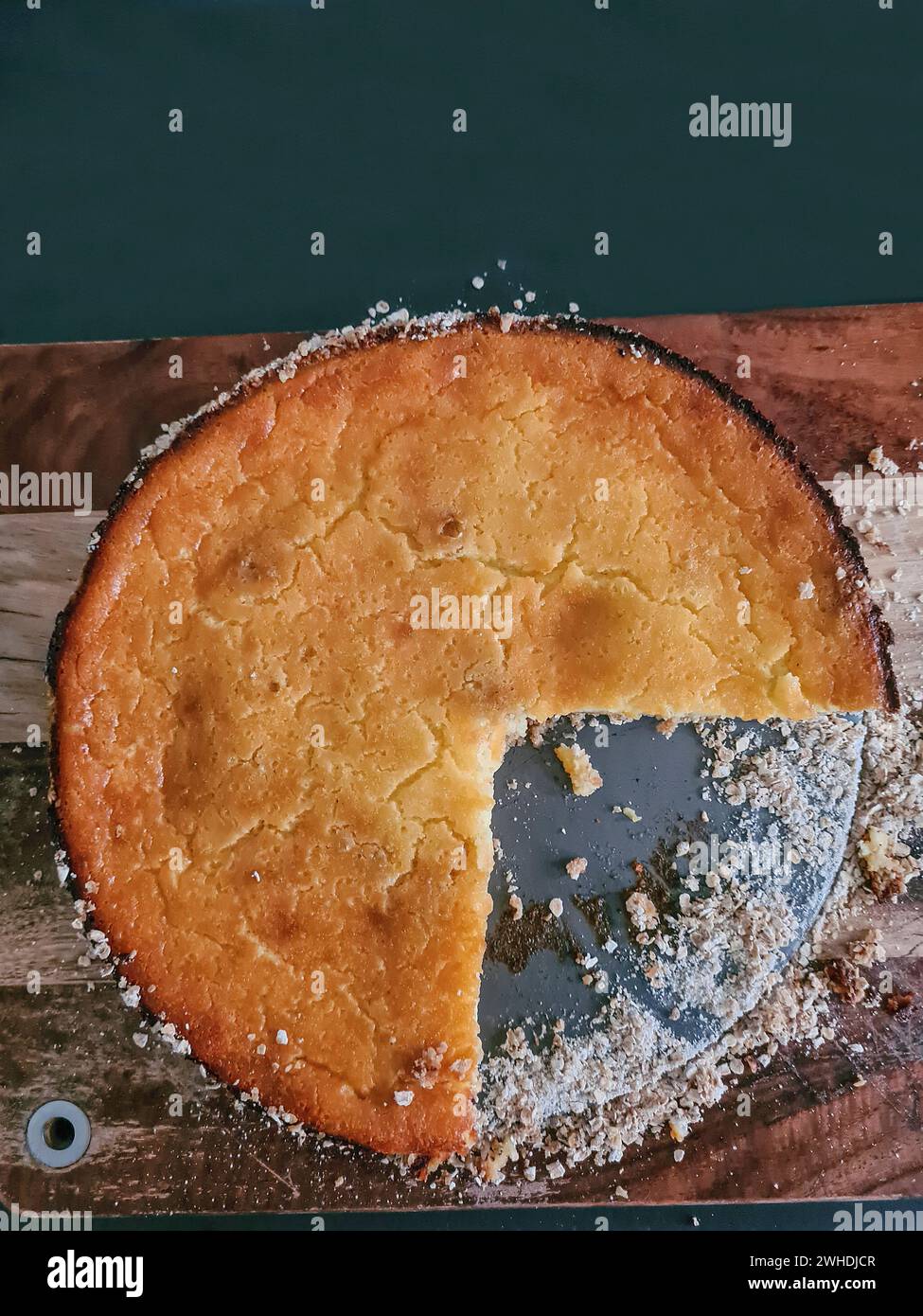 A quarter of the round cheesecake is missing from the bottom of the ...