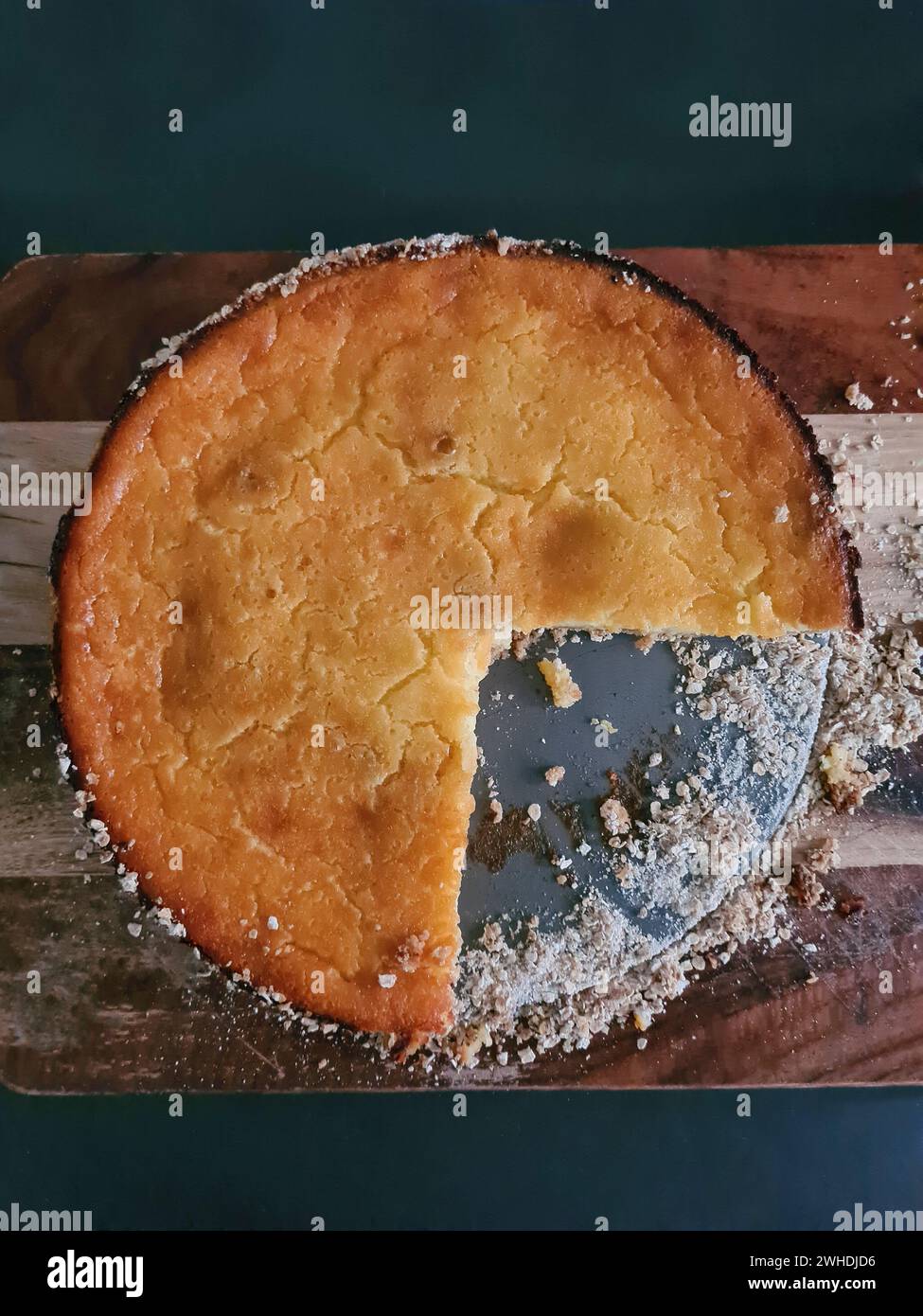 A quarter of the round cheesecake is missing from the bottom of the ...