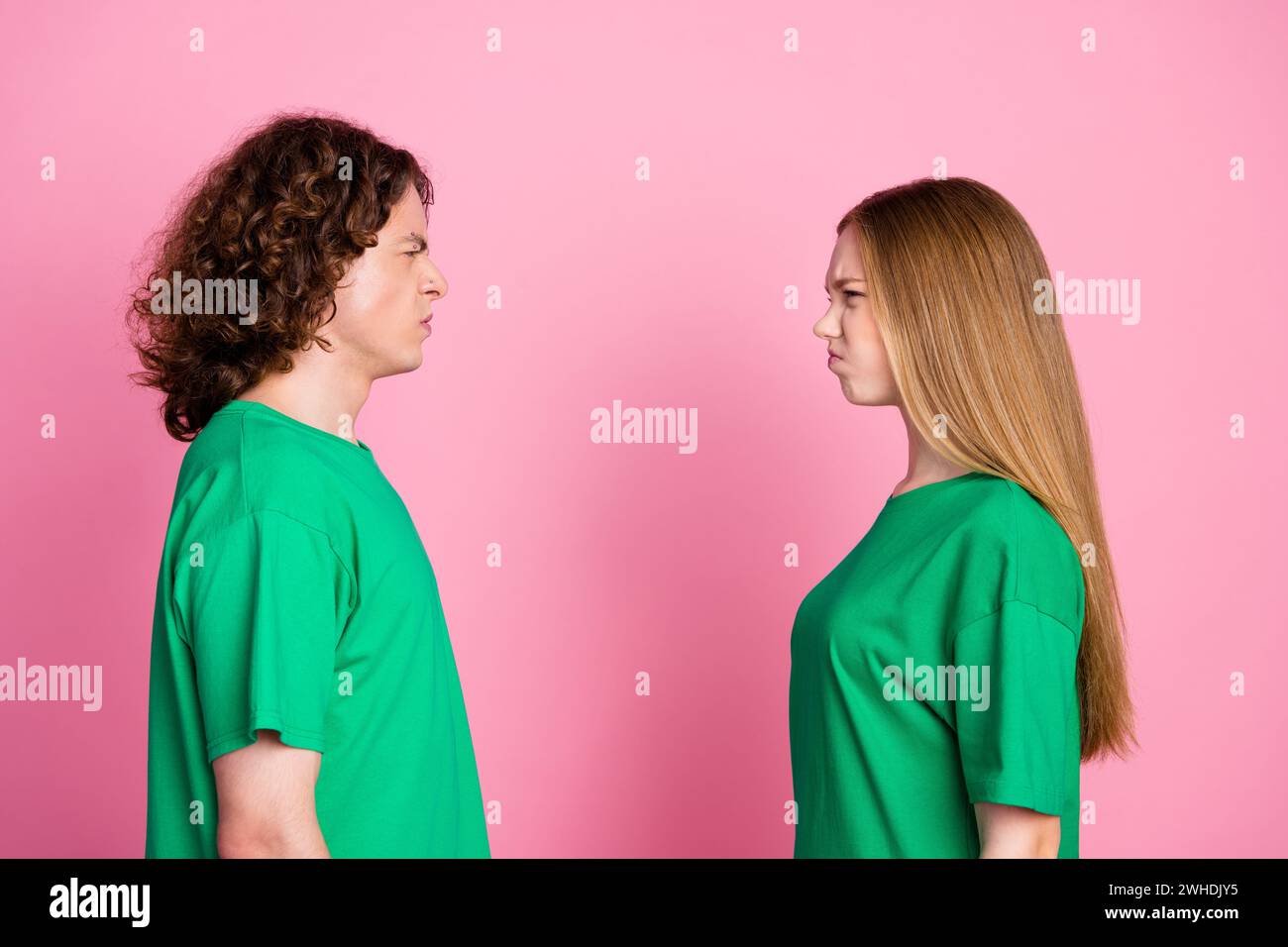 Side profile photo of two funny aggressive youth couple looking each ...