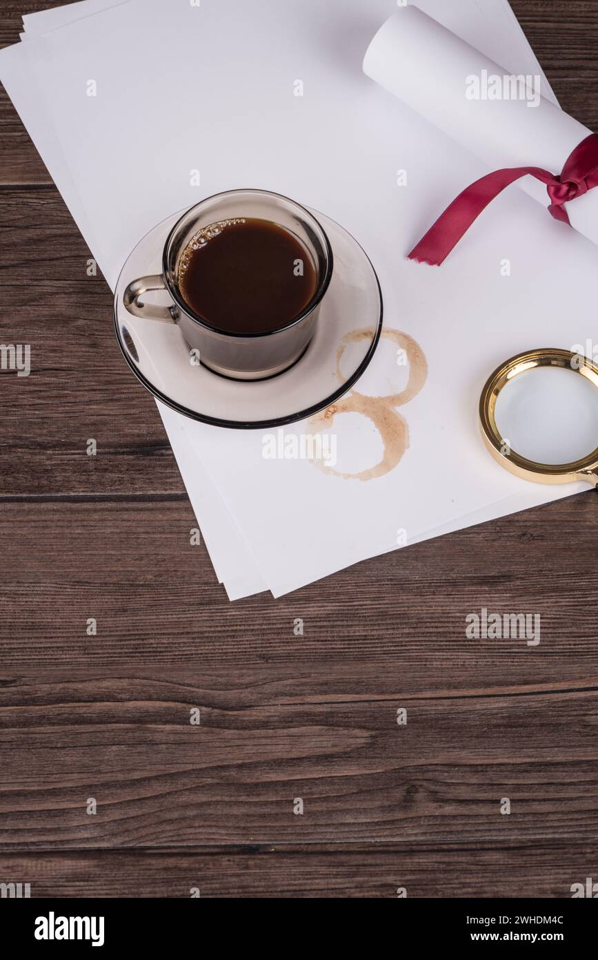 Coffee cup, paper sheets and detective hat Stock Photo - Alamy