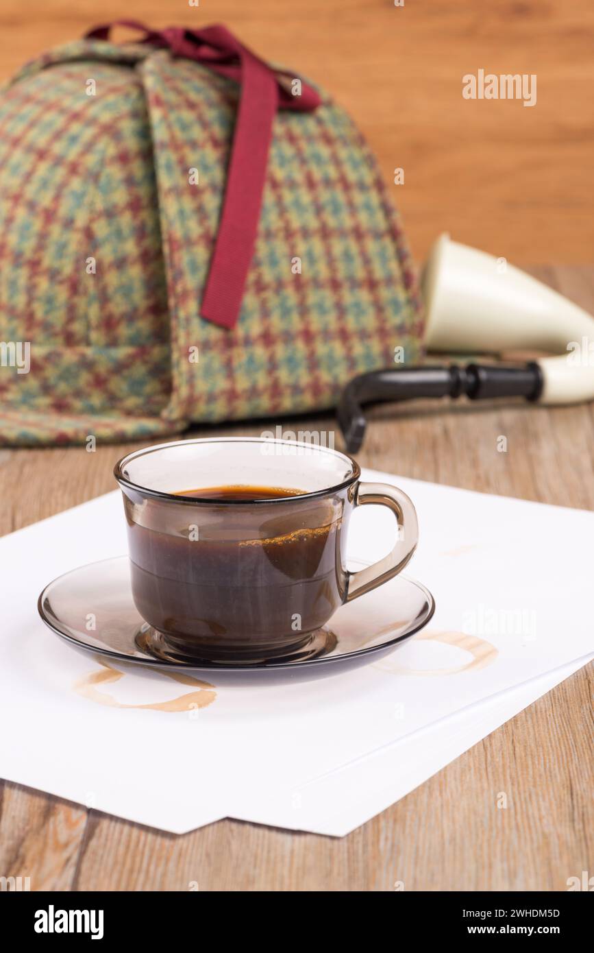 Coffee cup, paper sheets and detective hat Stock Photo - Alamy