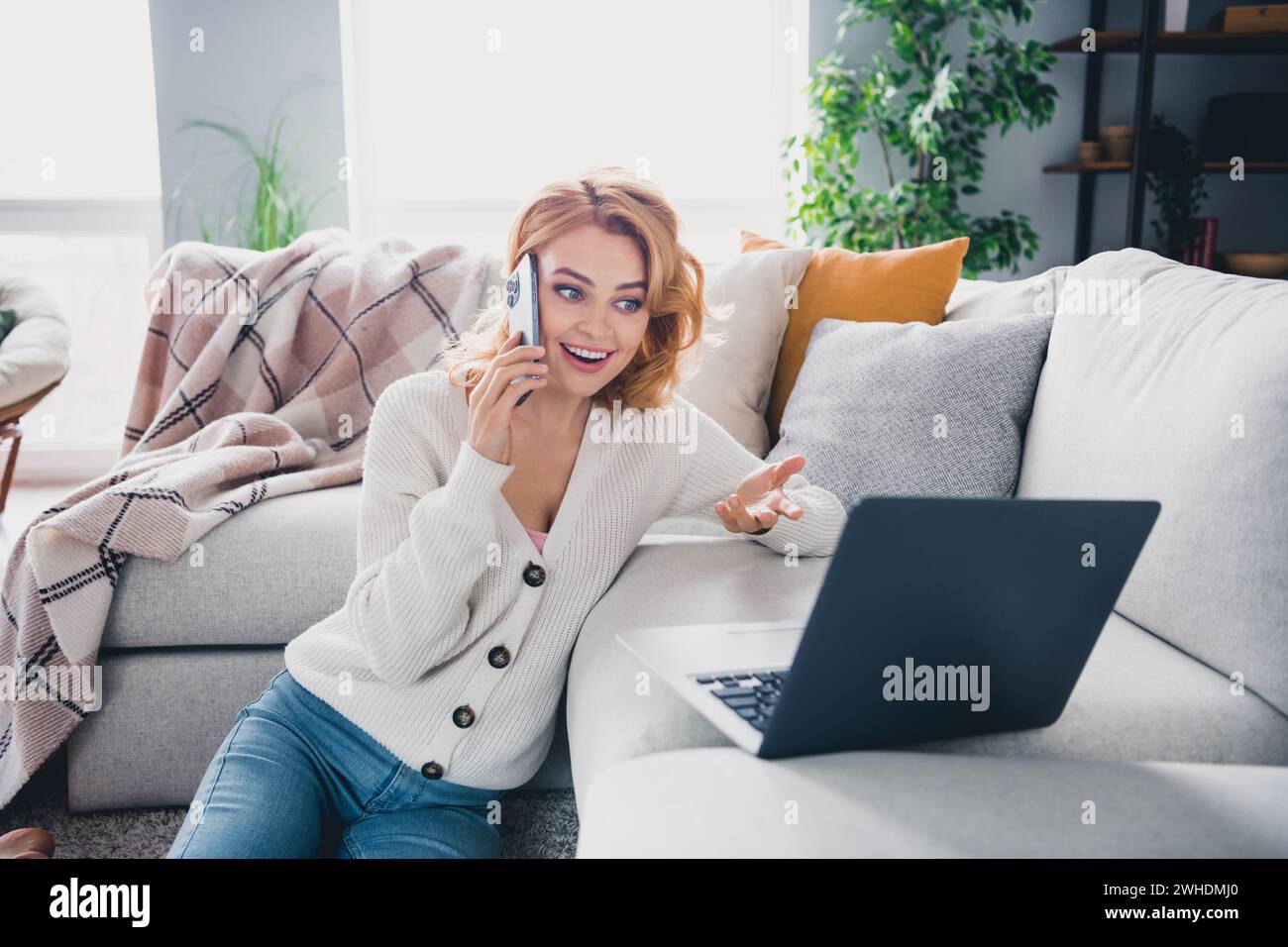 Portrait of pretty positive lady communicate telephone use netbook ...