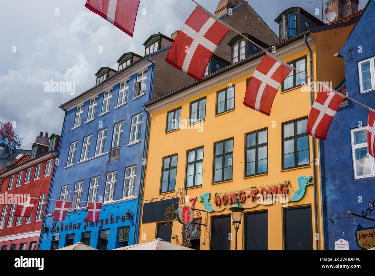 Vibrant Copenhagen Street View with Danish Flags and Cozy Cafes Stock ...