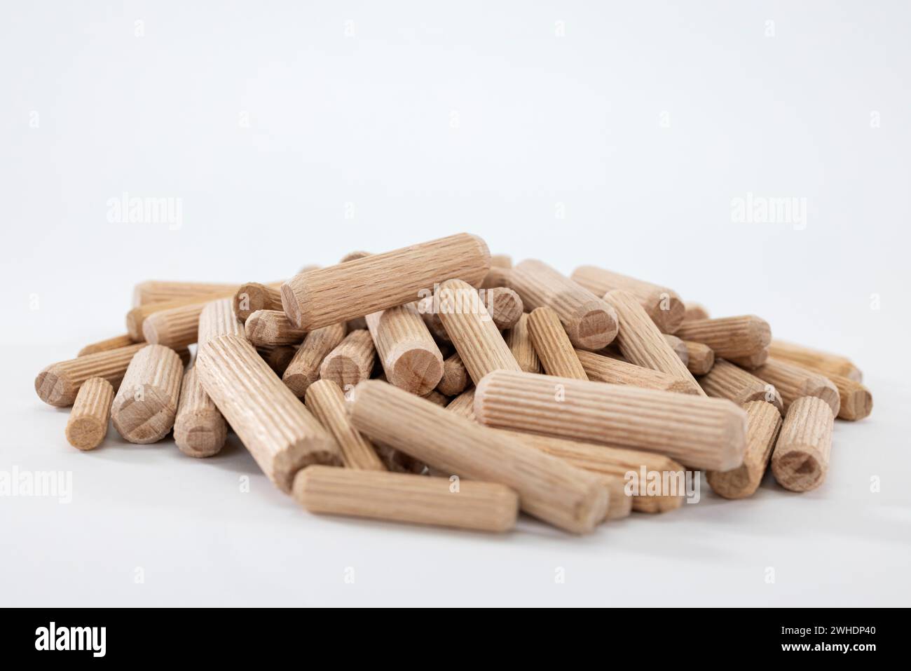 Many wooden dowels, various sizes, white background Stock Photo - Alamy