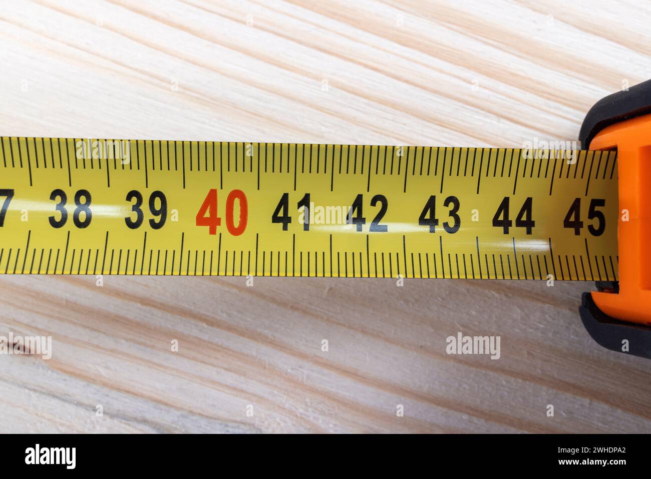 Measuring glulam panel, detail, yellow measuring tape with millimeter ...
