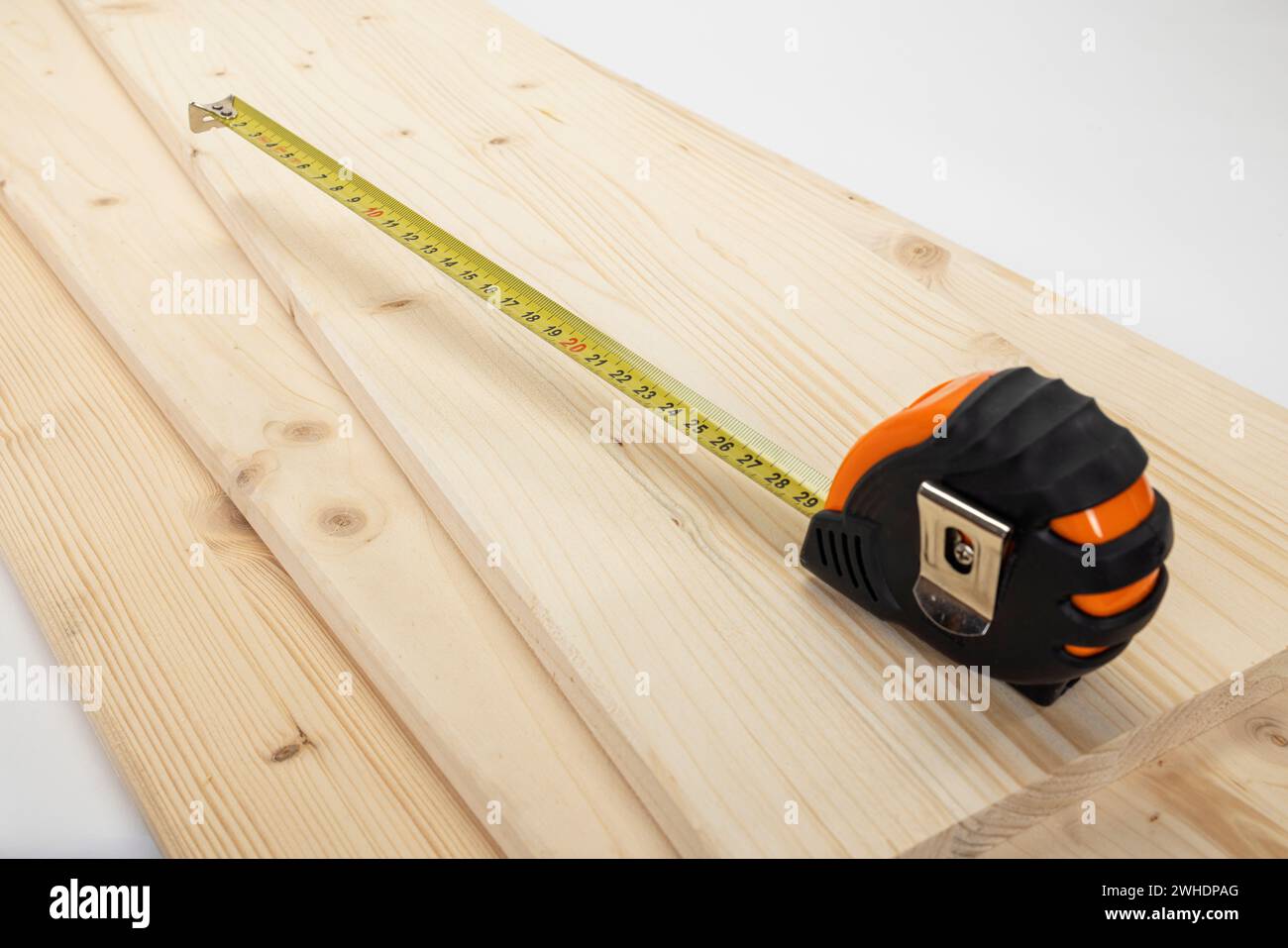 Yellow measuring tape with millimeter and centimeter graduations, rests ...