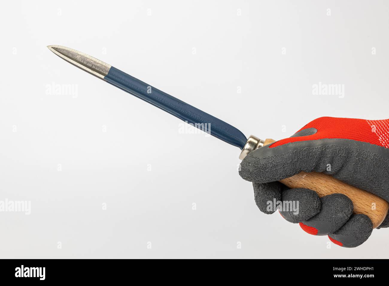 Man's hand with work glove holding a triangular scraper, white ...
