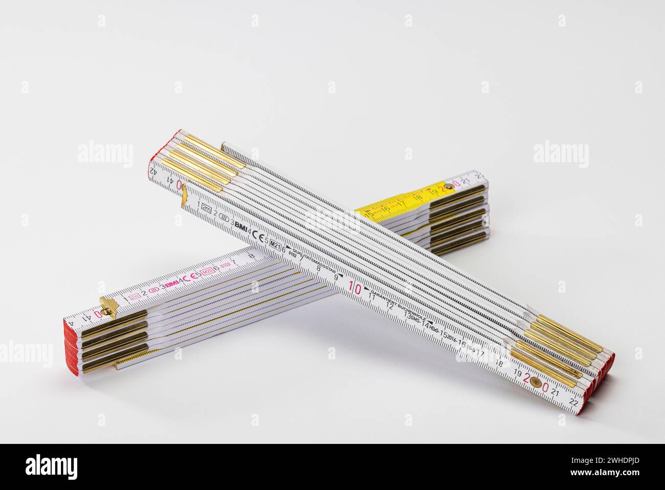 Two folding rules, folding ruler, white background Stock Photo - Alamy