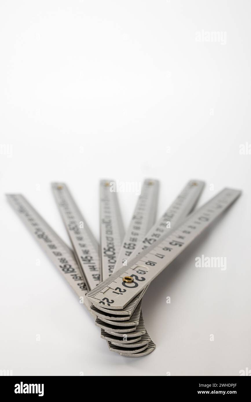 Metal folding rule, folding ruler, blur, white background Stock Photo ...