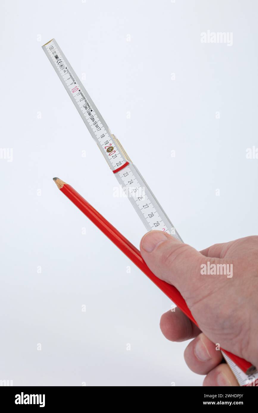 Man's hand holding folding rule with millimeter and centimeter ...