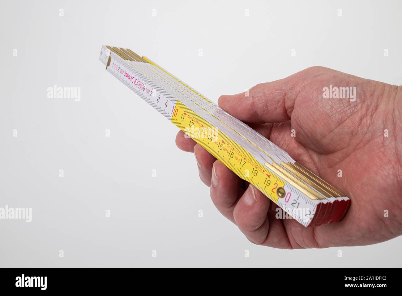 Male hand holding folding rule with millimeter and centimeter ...