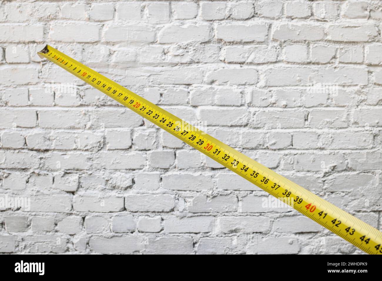 Yellow measuring tape with millimeter and centimeter divisions ...