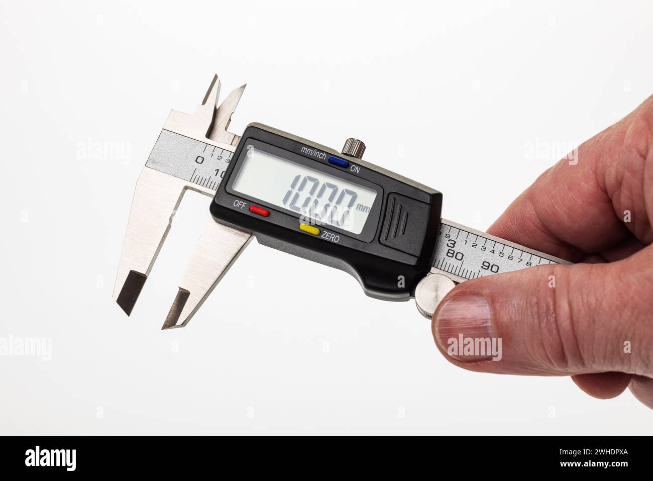 Man's hand holding electronic caliper, display, ten millimeter setting ...