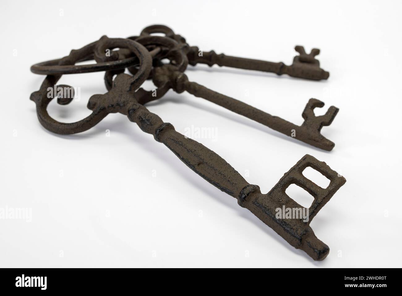 Three old decorative keys on a key ring, vintage, white background ...