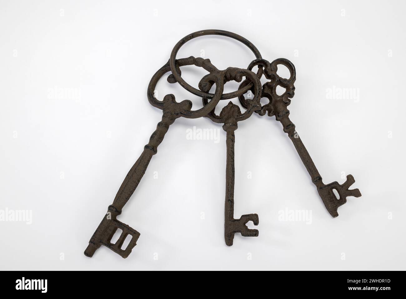 Three old decorative keys on a key ring, vintage, white background ...