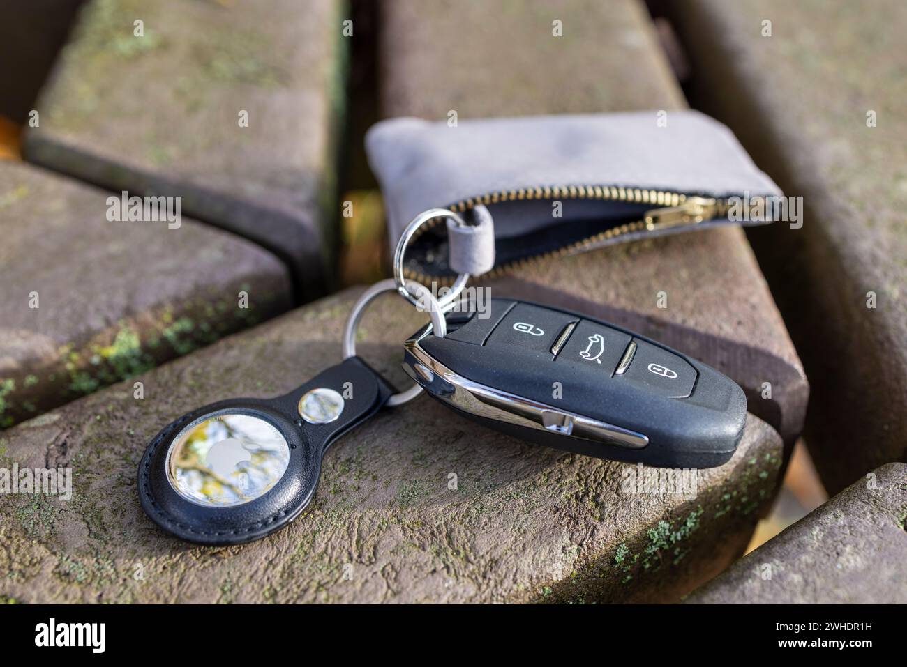 Car key with Apple AirTag left on a park bench, symbol image, key ...
