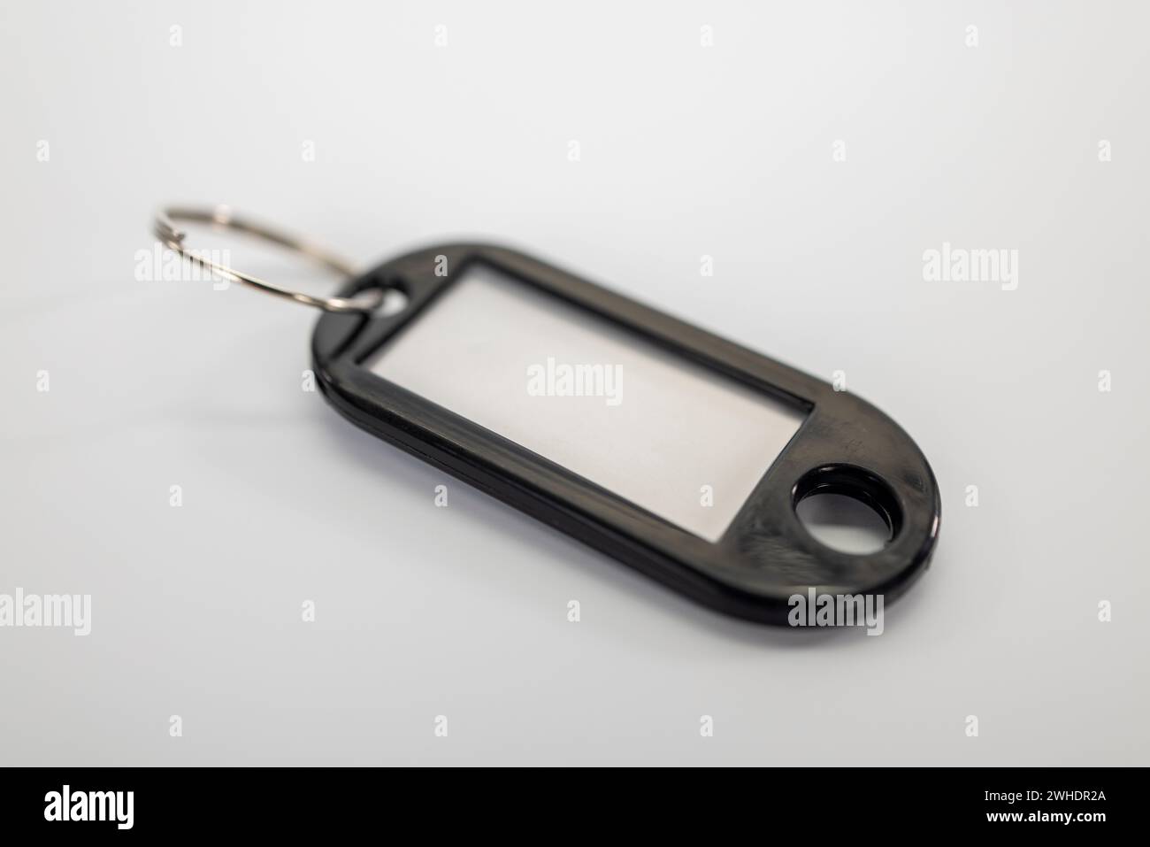 Black plastic key fob with ring, without lettering, white background ...