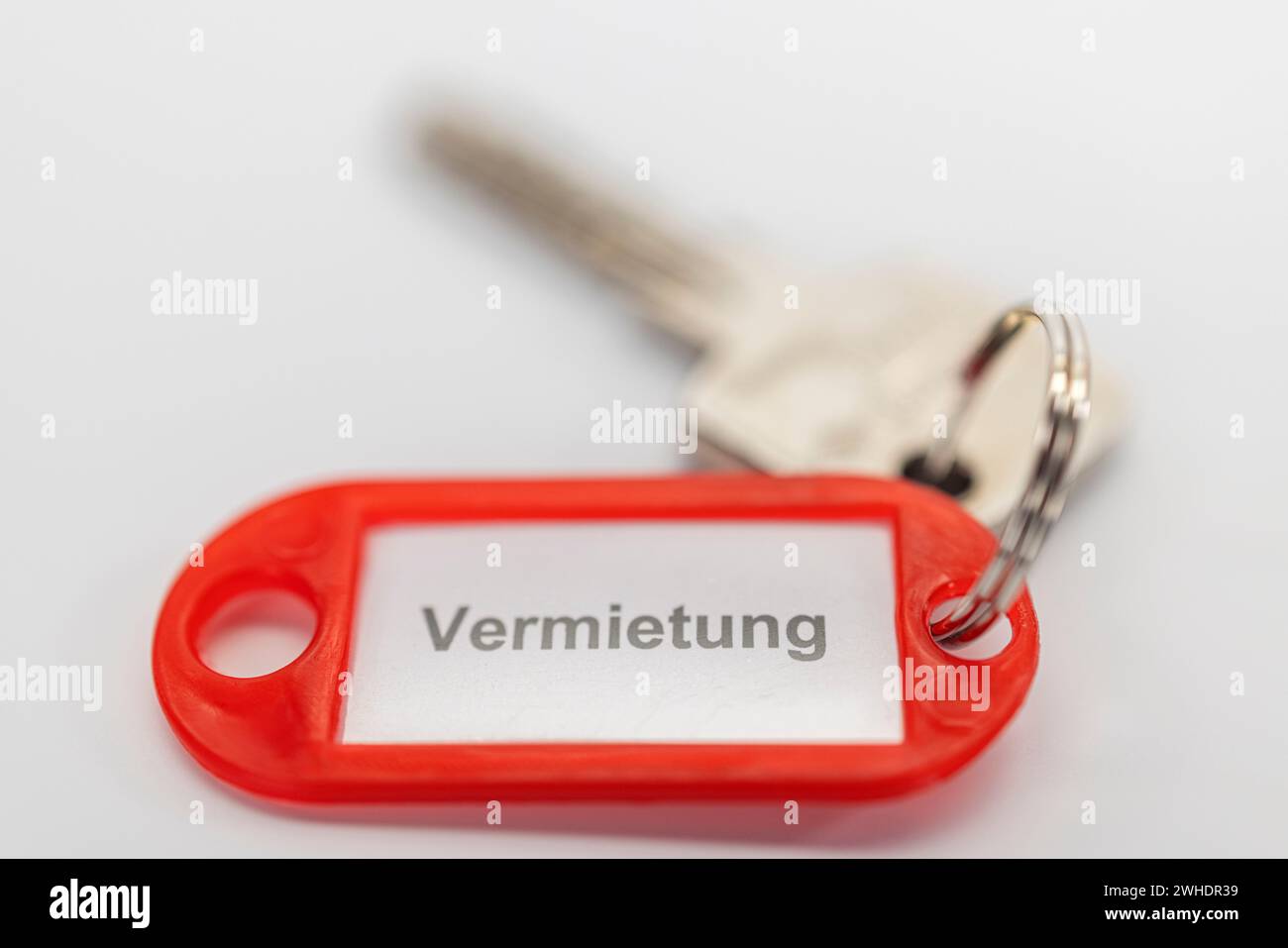 Key with red key ring, labeled ërentalë, well key, unsharp, white ...