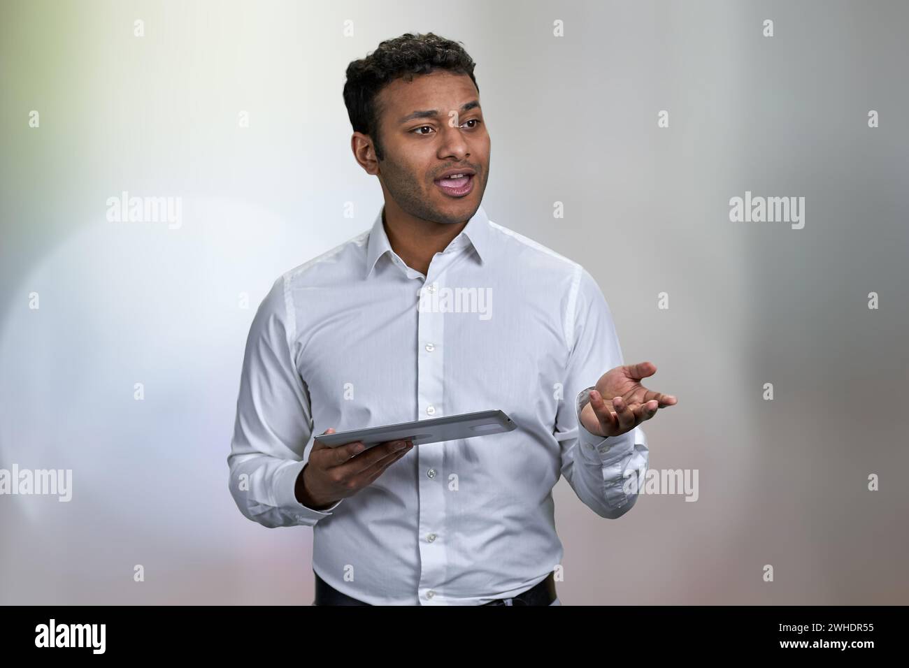 Successful Indian businessman presenting new project to employees using ...