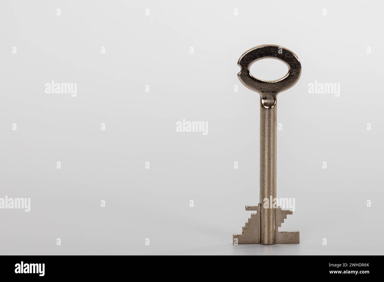 Key for a safe deposit box, white background Stock Photo - Alamy