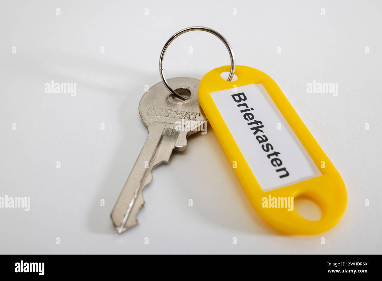 Key with yellow key ring, with lettering ëletterboxë, white background ...