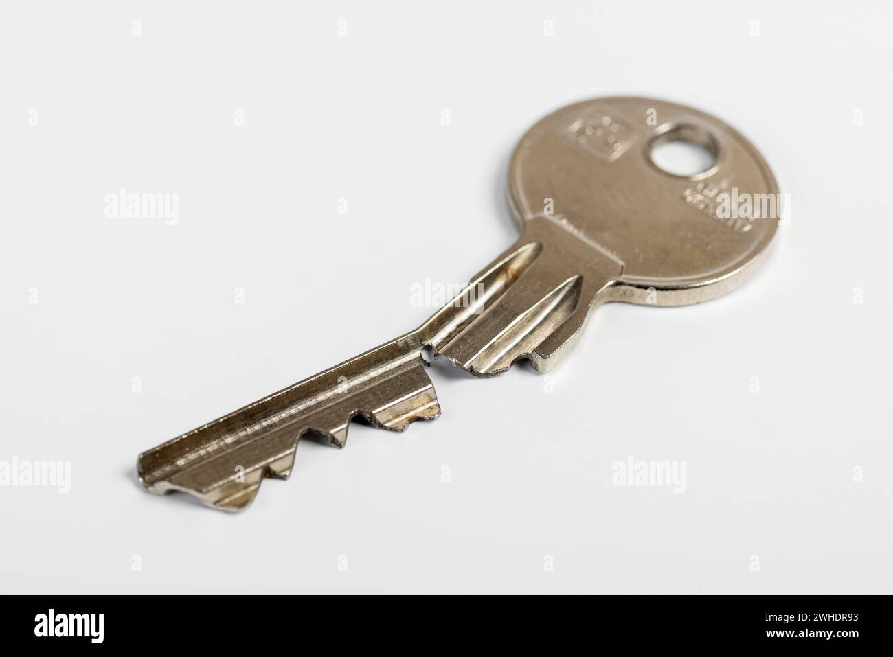 Opened door key, key bit, white background Stock Photo - Alamy