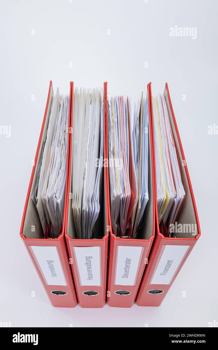 Red file folders labeled Rental, property management, tax consultant ...